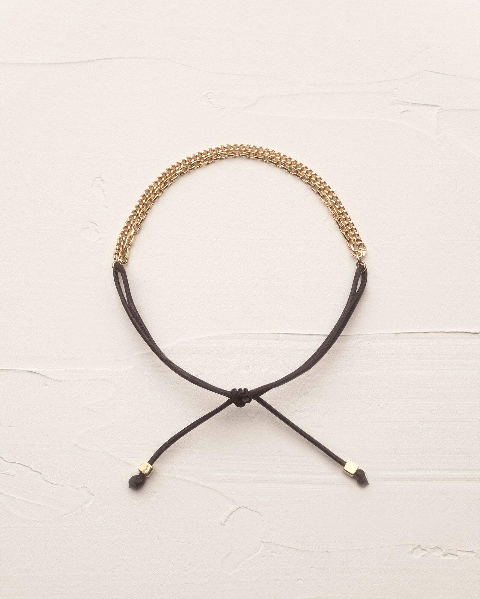 dual chain bracelet in 18K yellow gold and leather | Saint Laurent | YSL US